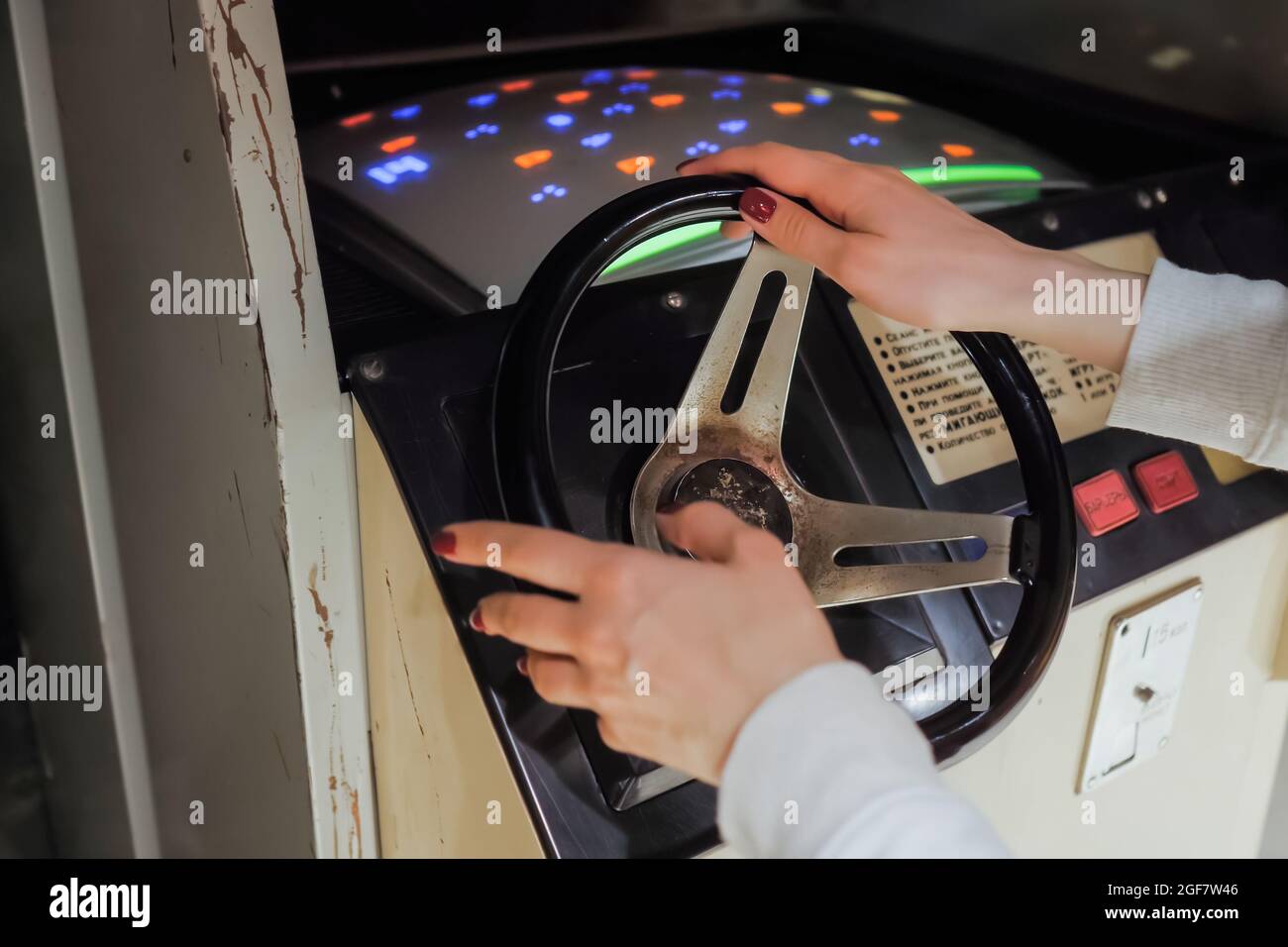 Woman gamer playing soviet retro racing arcade machine game Stock Photo ...