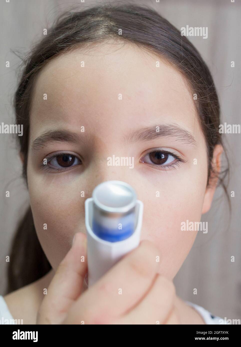 Child girl using medical spray for breath. Inhaler. Front view Stock ...