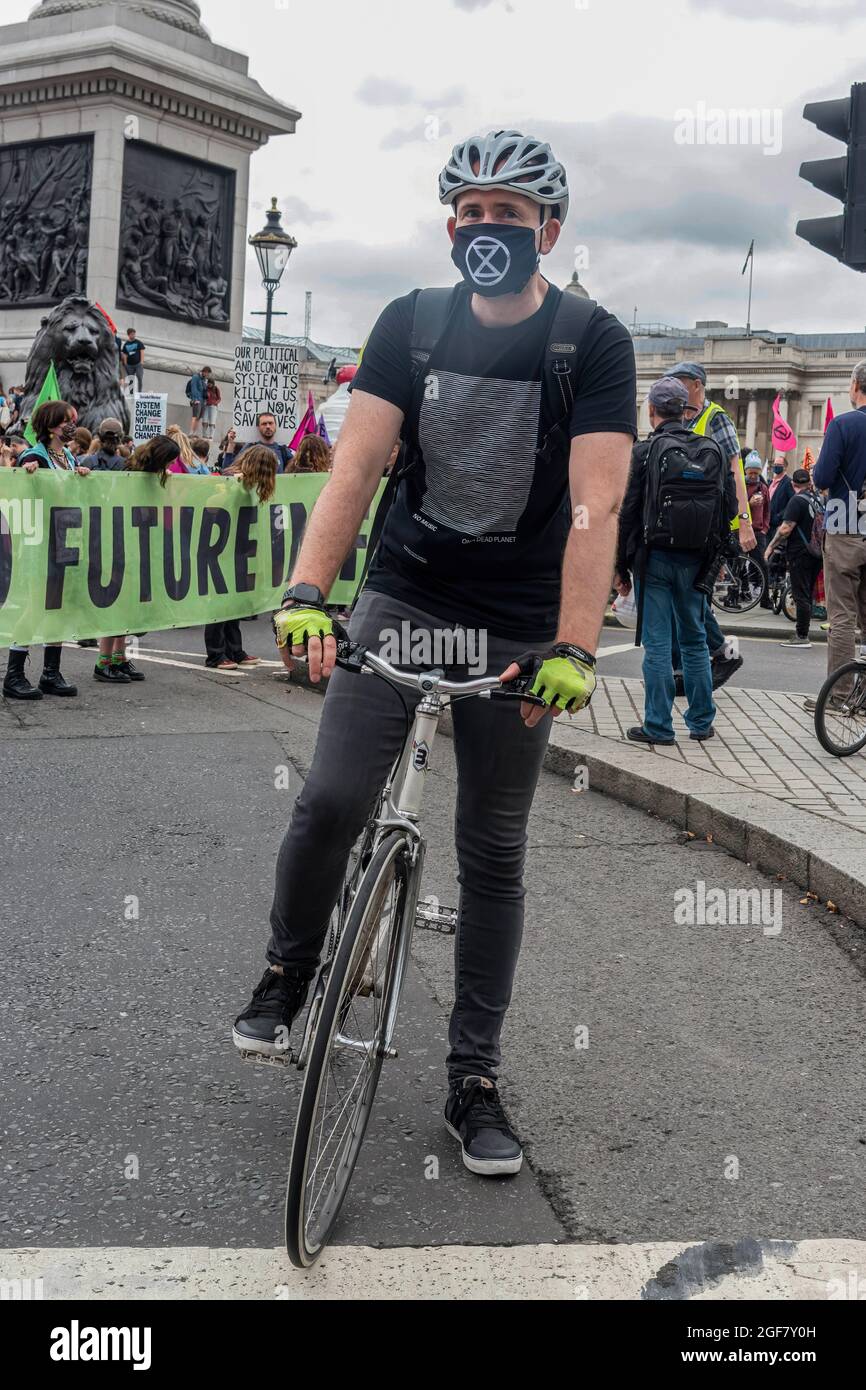 A cyclist with Extinction Rebellion face mask in London as they block ...