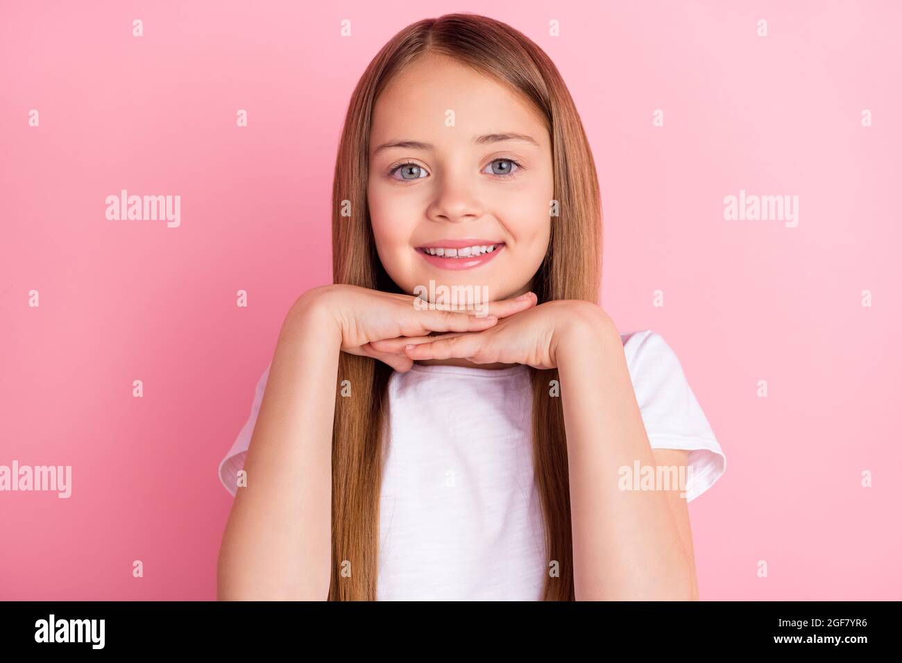 Photo of nice blond small girl hands face wear white t-shirt isolated ...
