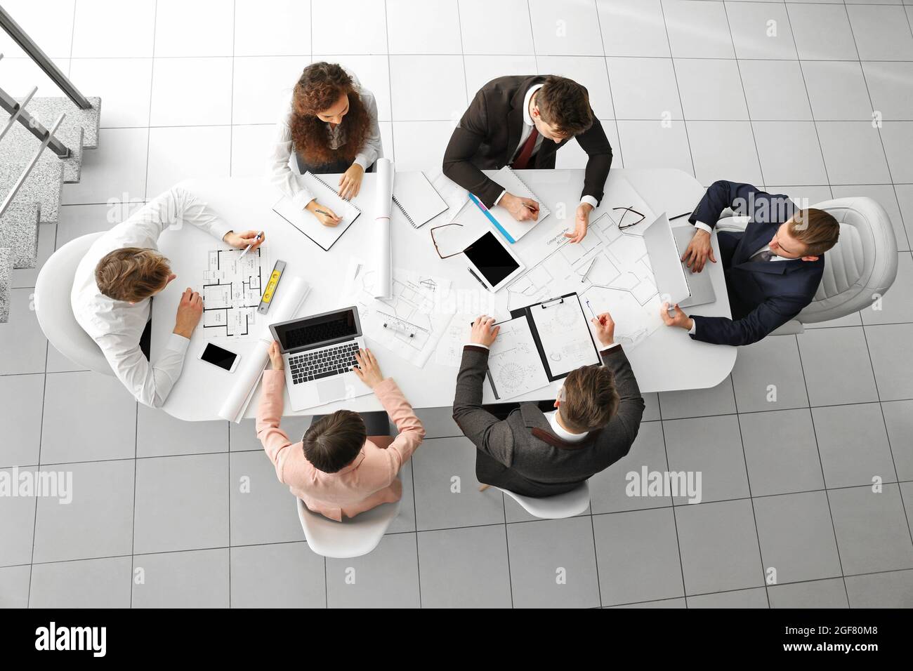 Team of professional engineers working with blueprints Stock Photo - Alamy