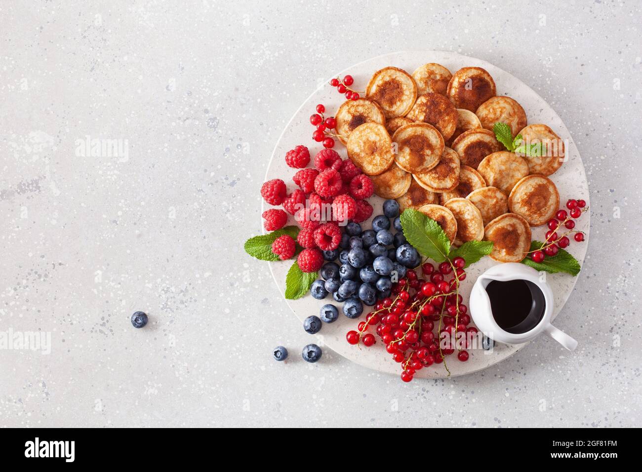 american mini pancake board with berries and maple syrup Stock Photo ...