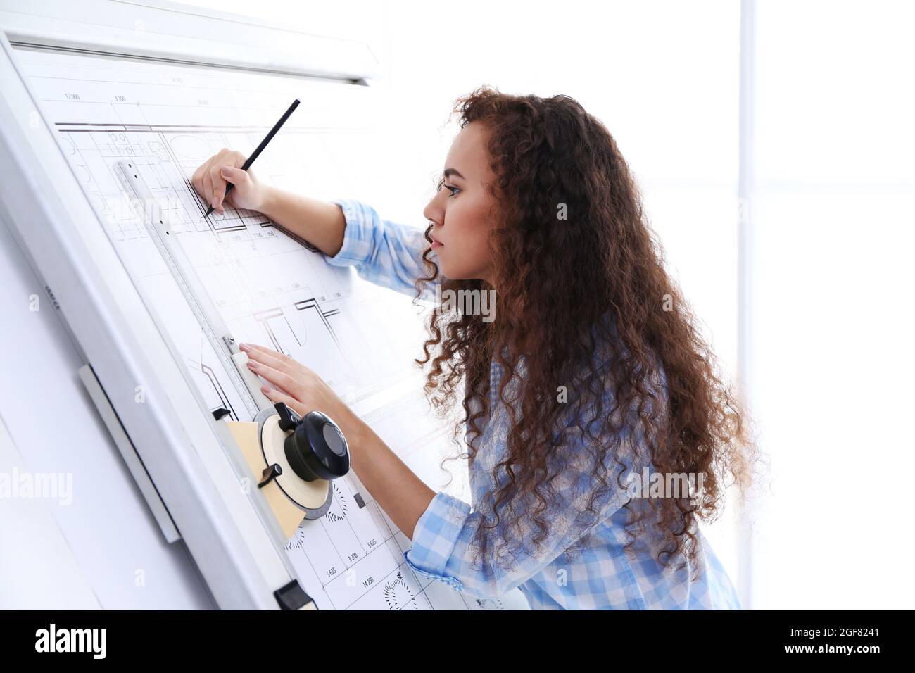 Female architects working on blueprints Stock Photo - Alamy