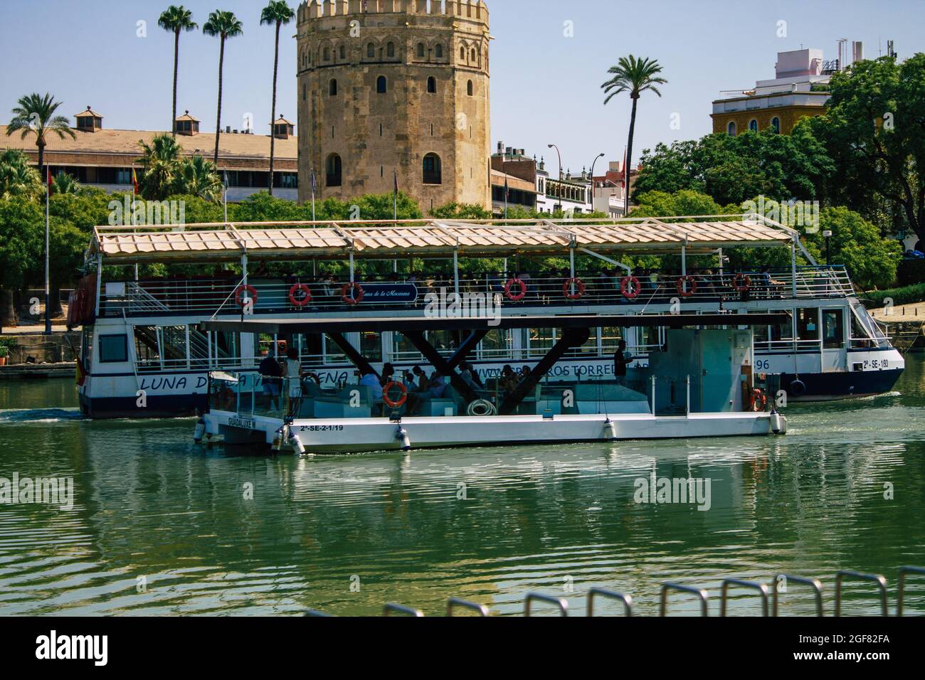 Seville Spain August 21, 2021 Tourist boats on the Guadalquivir River ...
