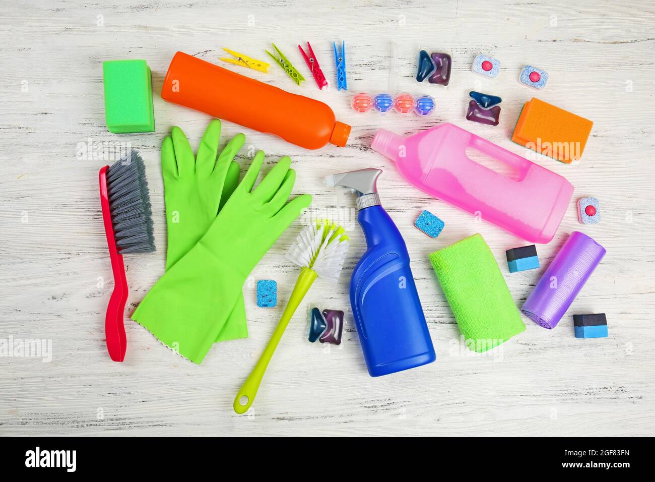 Cleaning set with tools and products on light wooden background Stock ...
