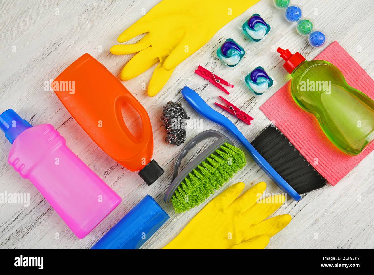 Cleaning set with tools and products on light wooden background Stock ...