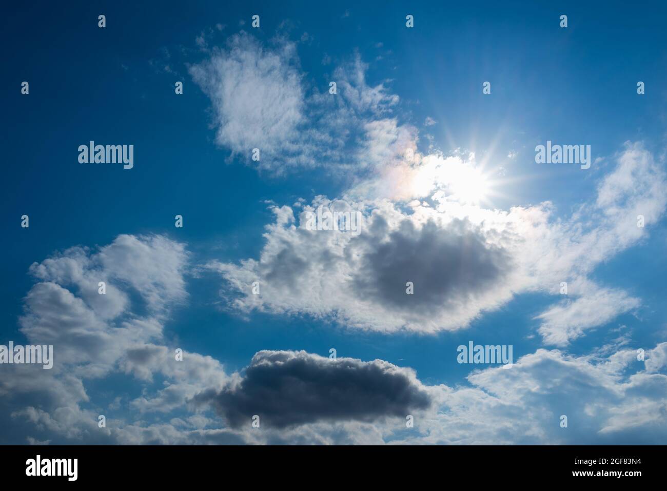 Dramatic blue sky with clouds and sun rays.Summer Sun rays at evening ...