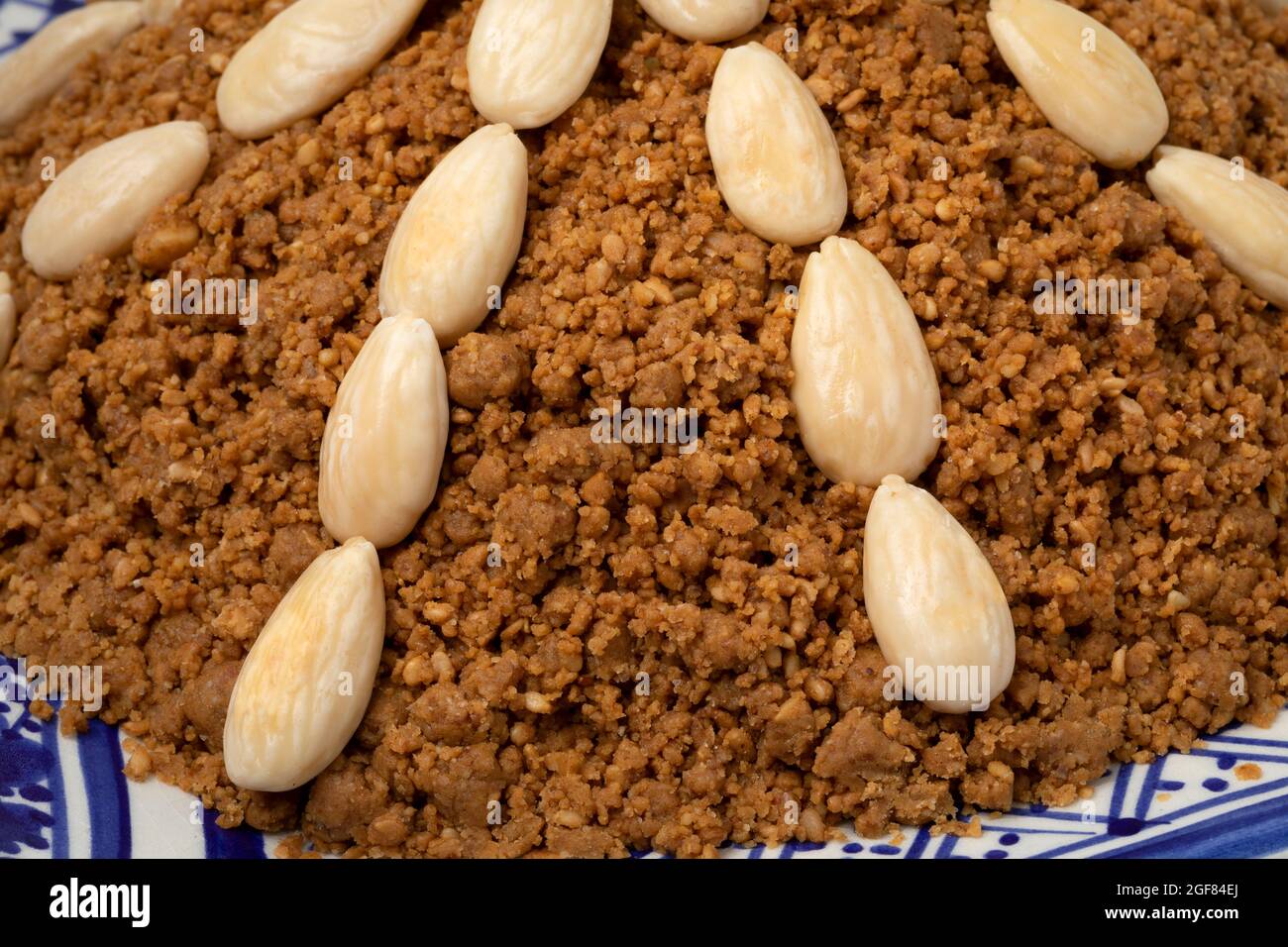 Traditional Moroccan homemade sellou decorated with roasted almonds ...