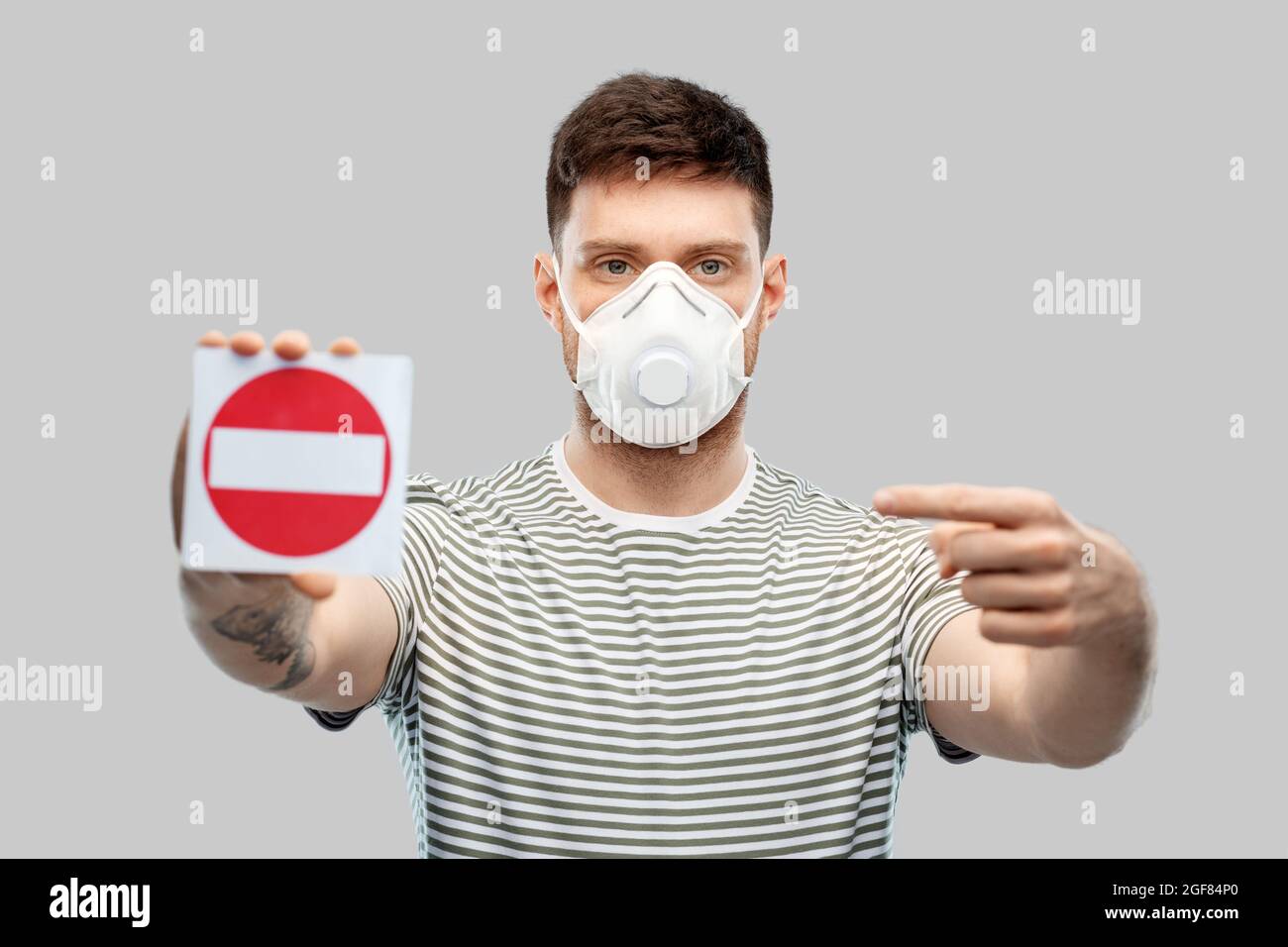 man in respirator mask showing stop sign Stock Photo - Alamy