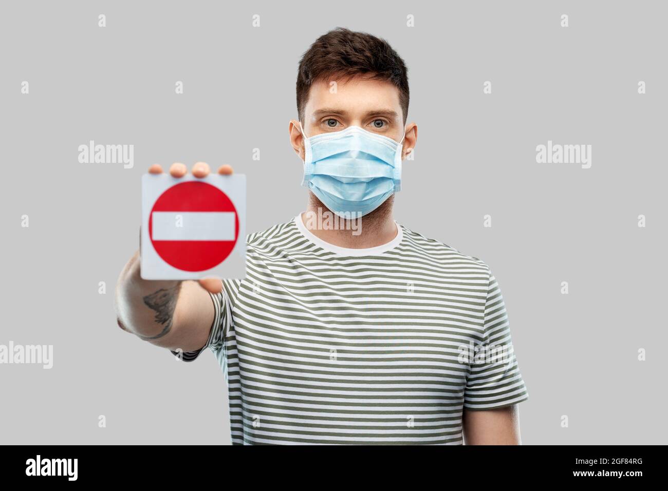 young man girl in medical mask showing stop sign Stock Photo - Alamy