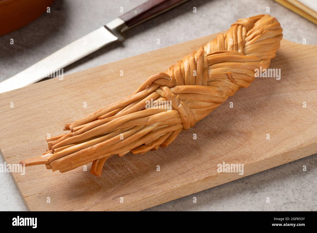 Smoked braided cheese, called Chechil, from the Adyghe Republic on a ...