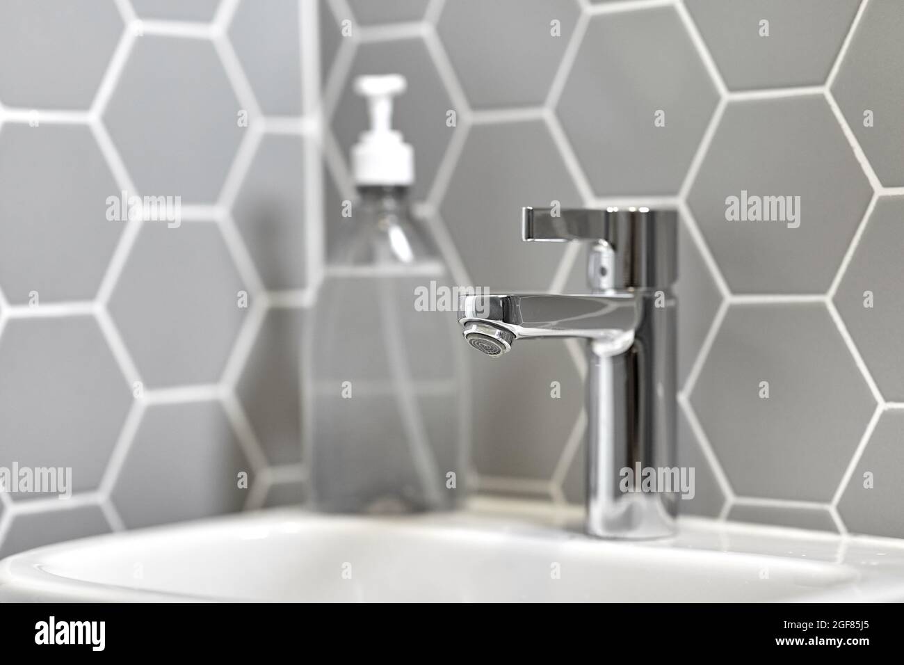 close up of water tap with liquid soap on sink Stock Photo - Alamy