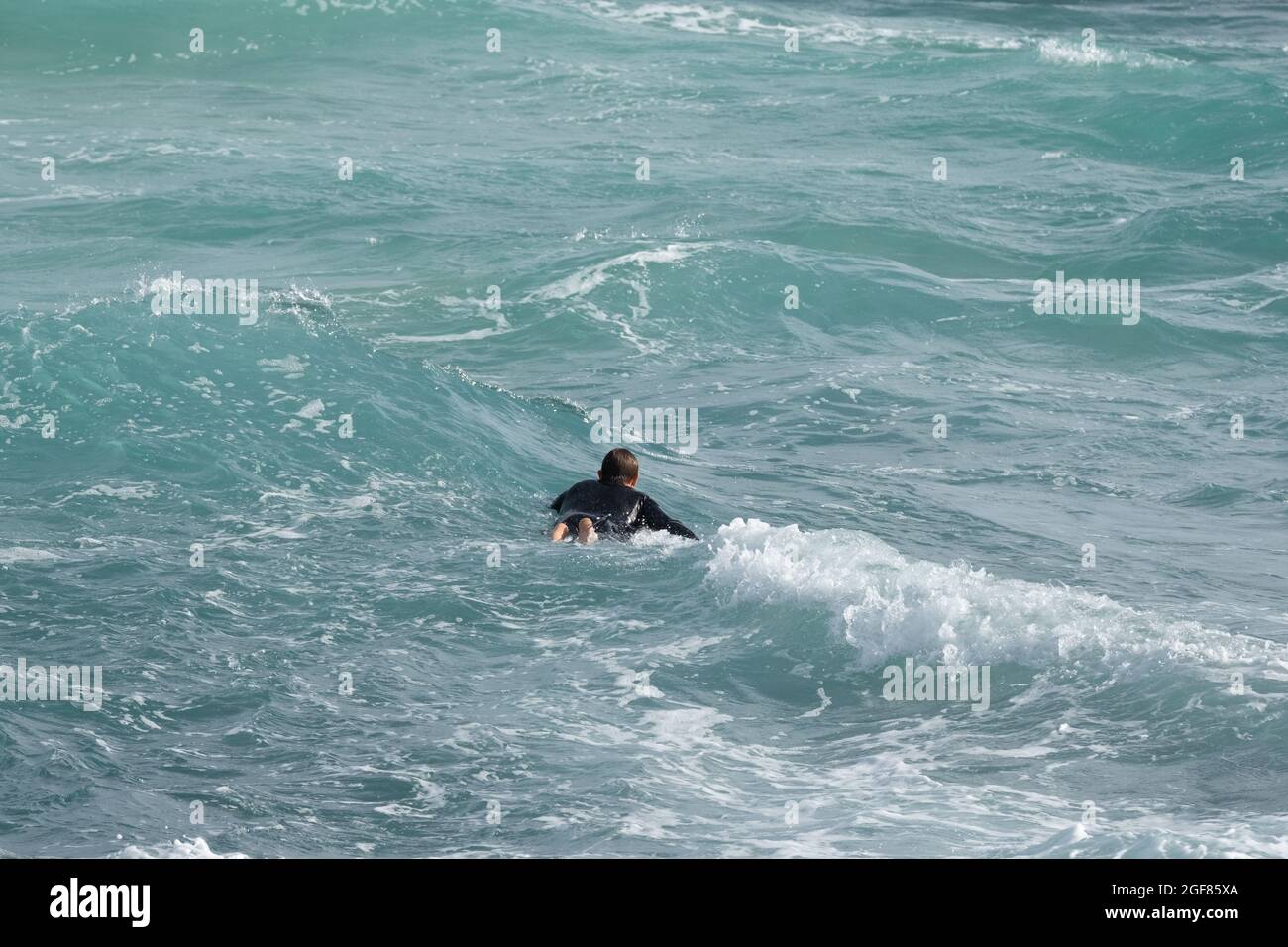 Surfer paddling out to surf, Redgate Beach, Western Australia Stock ...