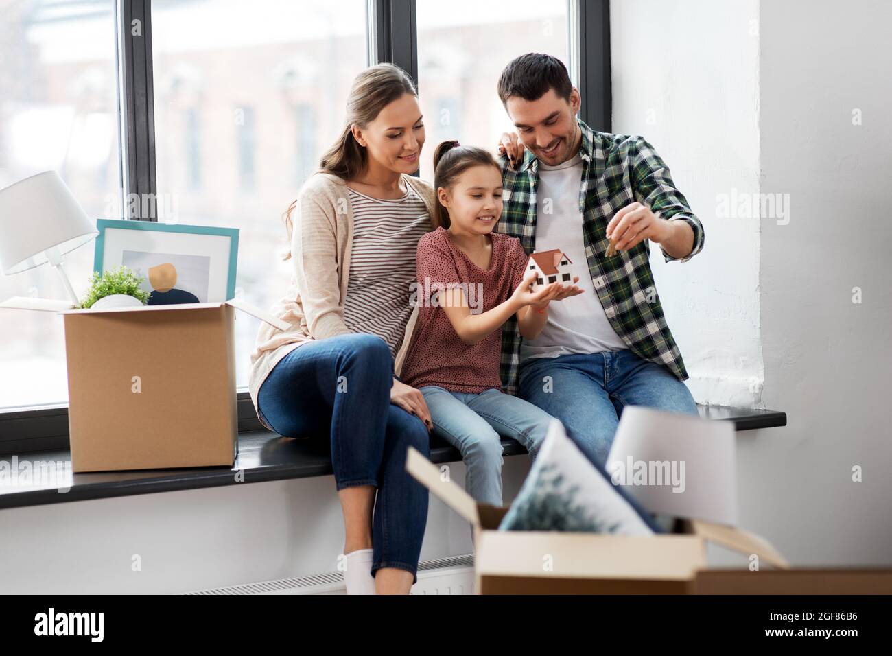 happy family with house model moving to new home Stock Photo - Alamy