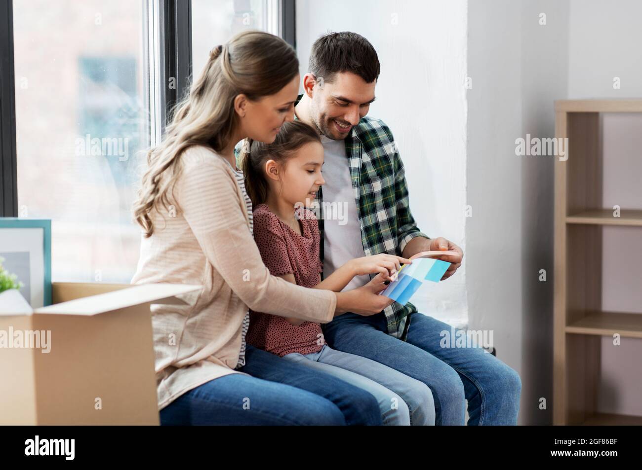 happy family with color palette moving to new home Stock Photo - Alamy
