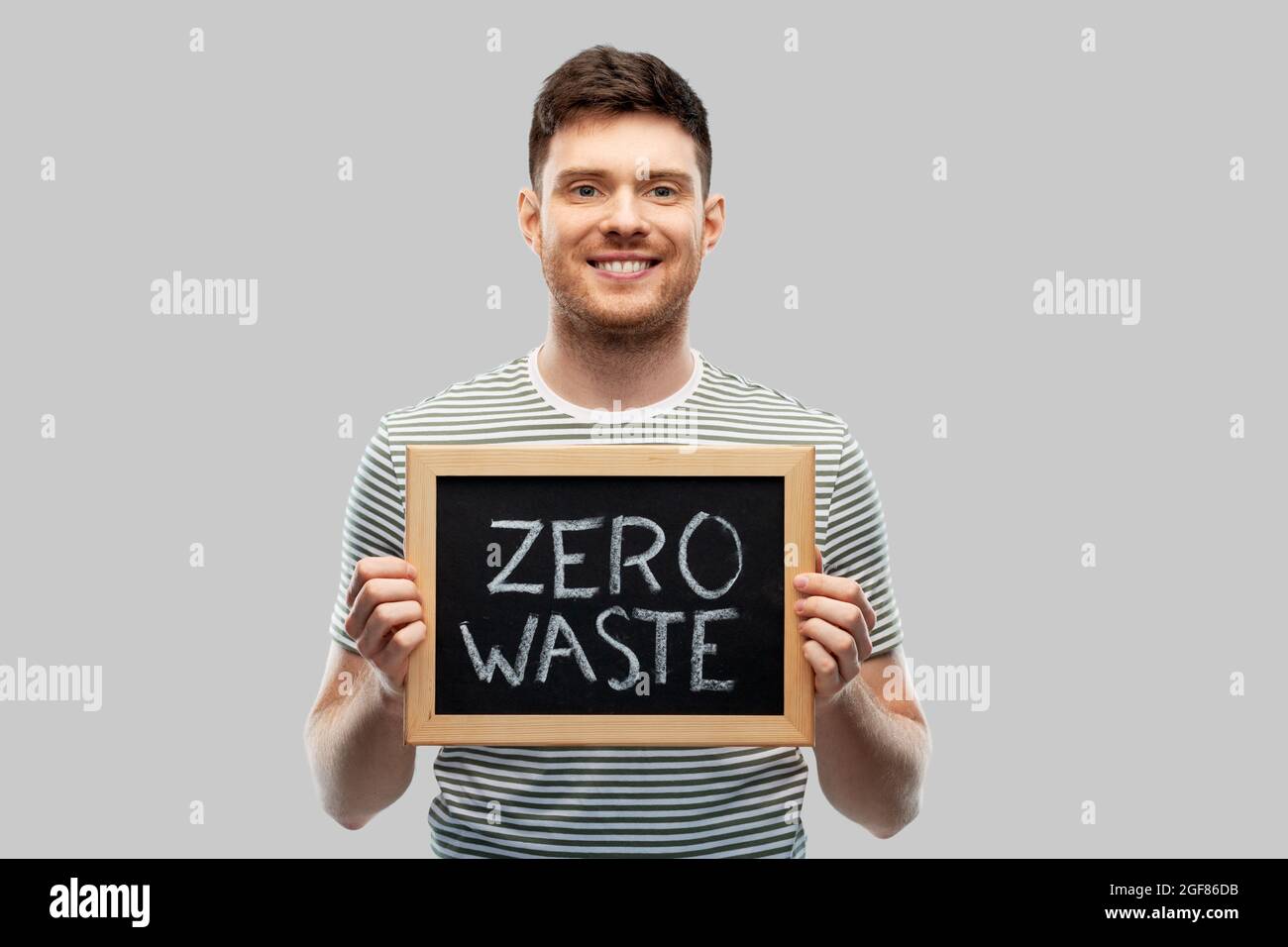smiling man holding chalkboard with zero waste Stock Photo - Alamy