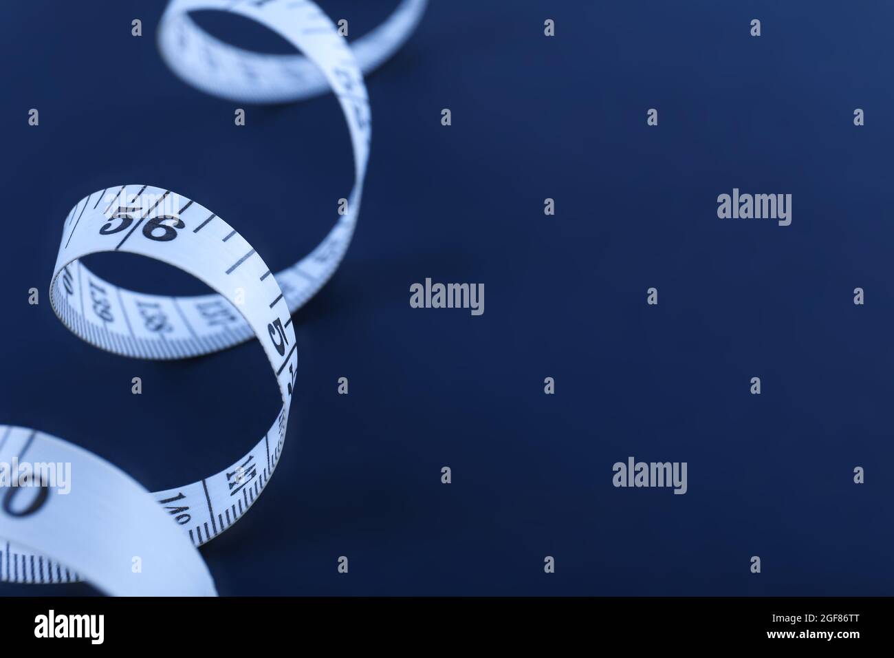 White measuring tape on a black background Stock Photo - Alamy