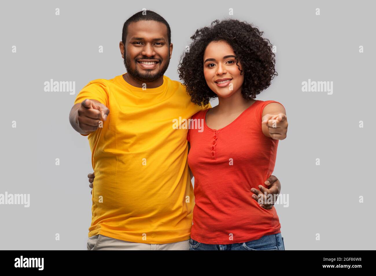 happy african american couple pointing to camera Stock Photo - Alamy