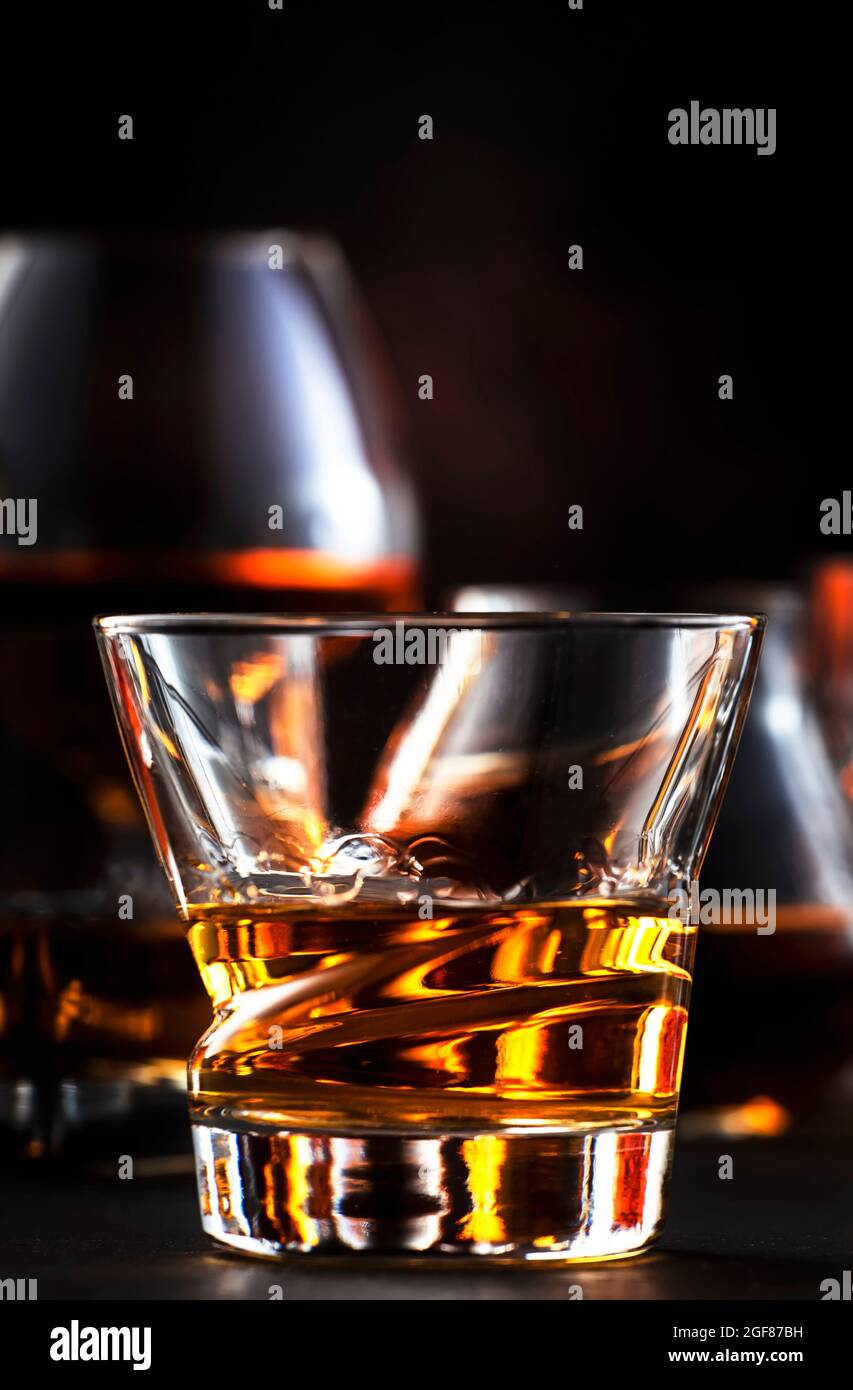Strong alcohol drinks, hard liquors, spirits and distillates in glasses ...