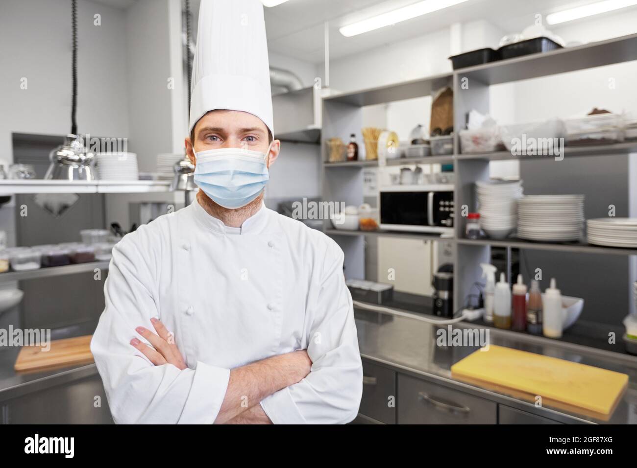 male chef cook in face mask at restaurant kitchen Stock Photo - Alamy