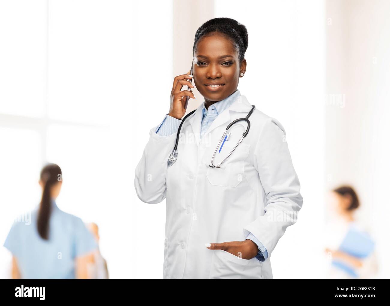 african female doctor calling on smartphone Stock Photo - Alamy