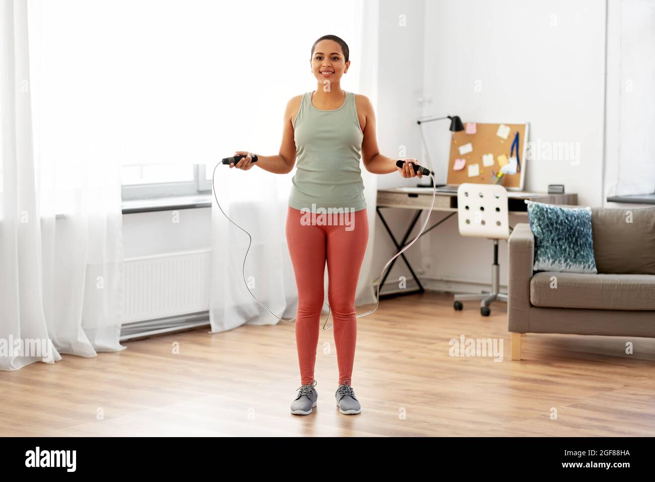 african woman exercising with jump rope at home Stock Photo - Alamy