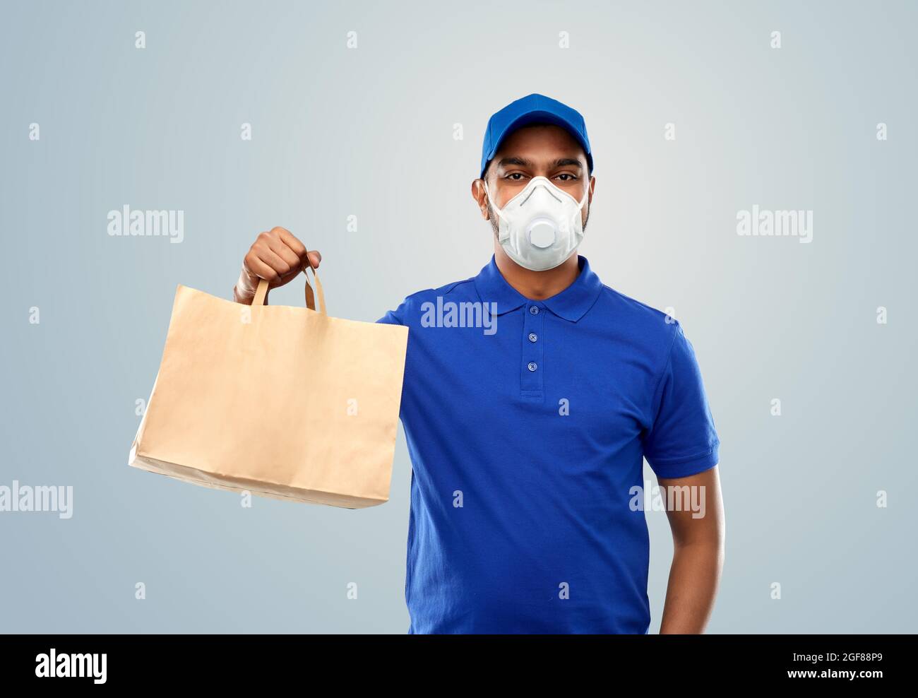 delivery man in respirator mask with paper bag Stock Photo - Alamy