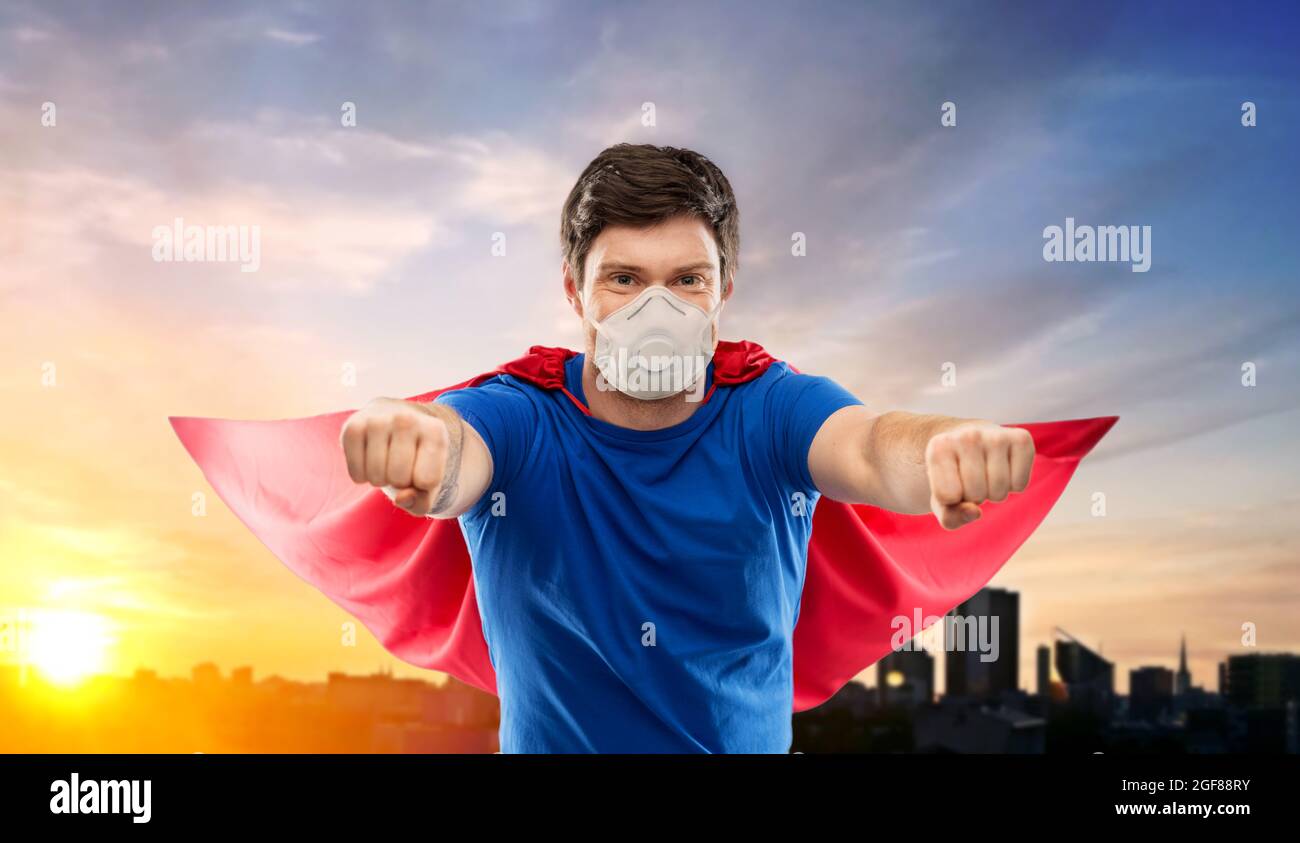 superhero man in respirator flying over city Stock Photo - Alamy