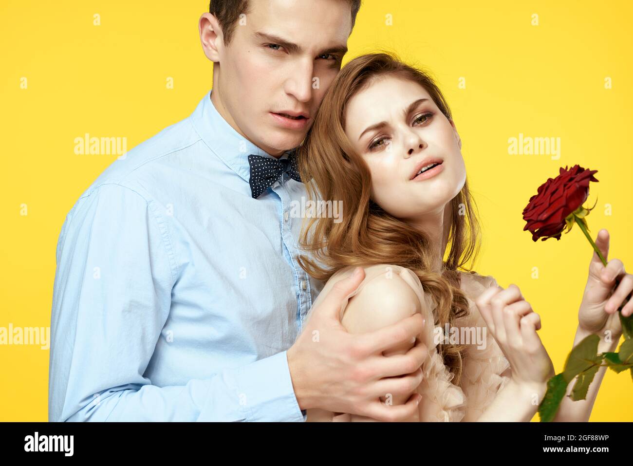 young couple hugs romance passion rose flower yellow background Stock ...