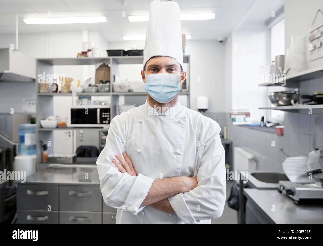 male chef with in face mask at restaurant kitchen Stock Photo - Alamy