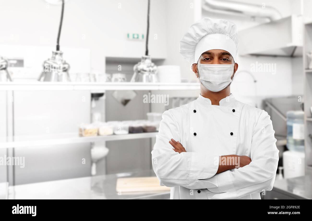 male chef in face mask at restaurant kitchen Stock Photo - Alamy