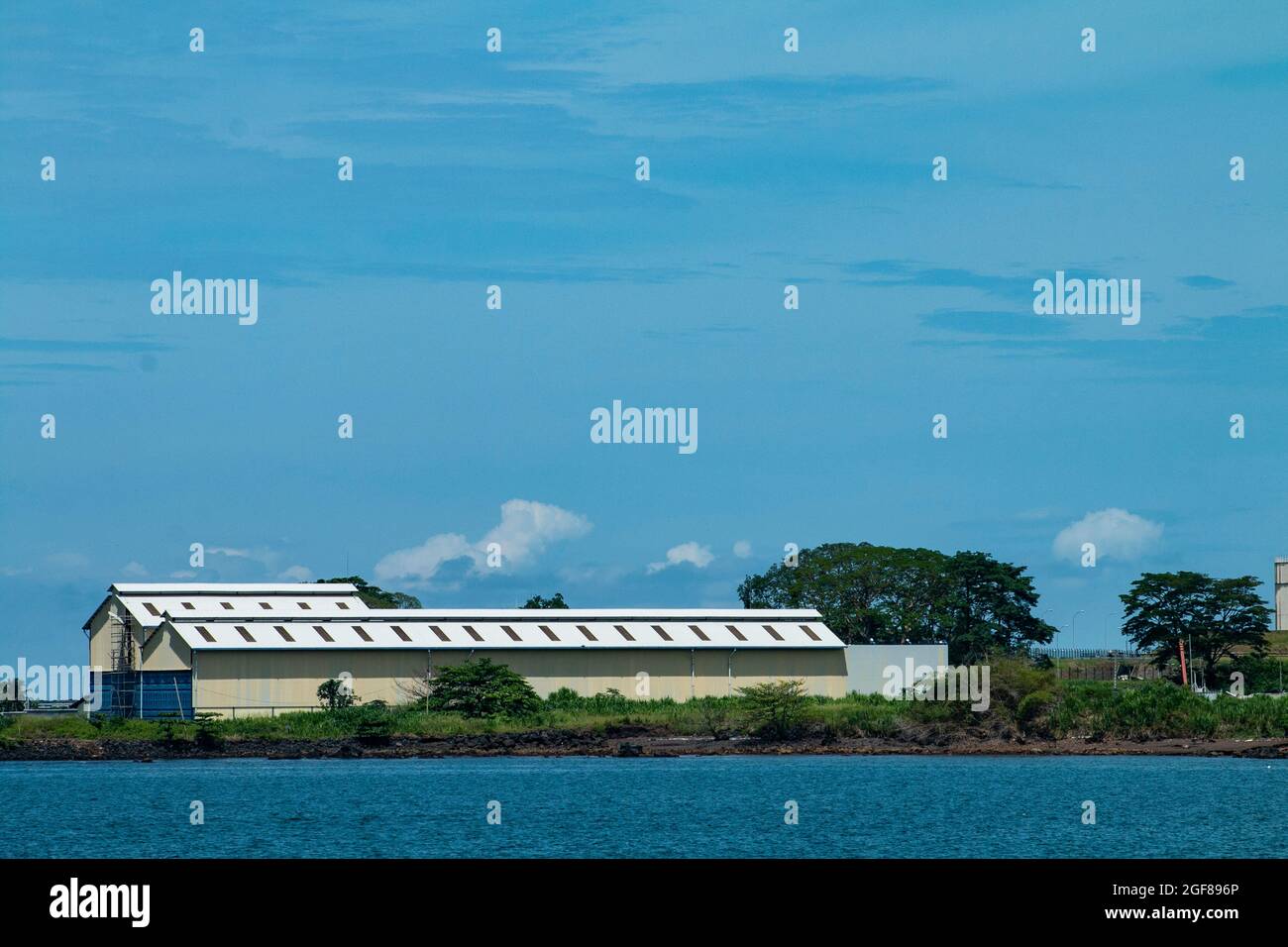 Yellow warehouse by the sea in Cameroon with blue skies in the ...