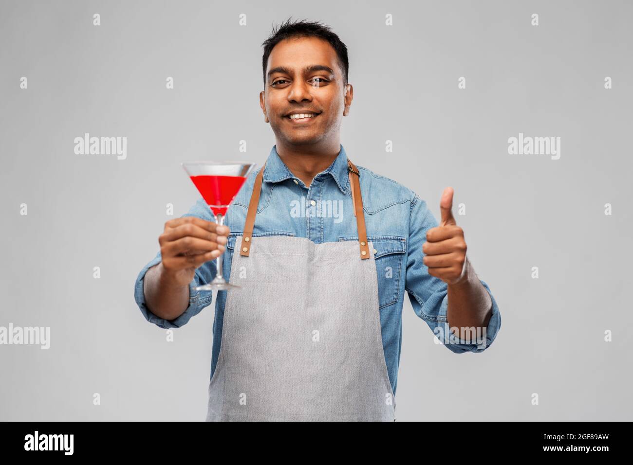 indian barman in apron with glass of cocktail Stock Photo - Alamy