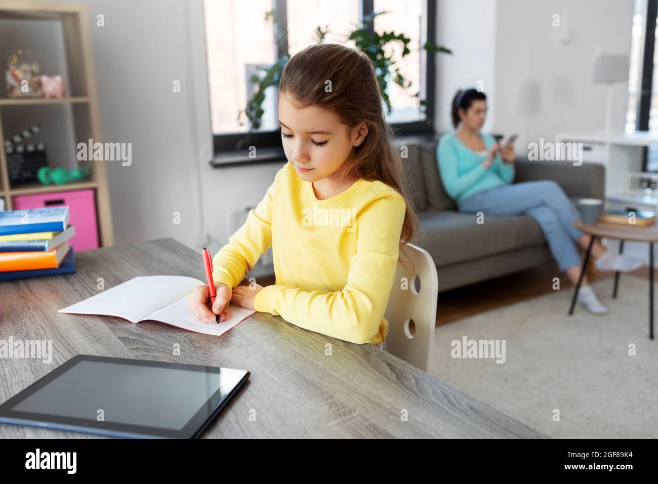 student girl with tablet pc learning at home Stock Photo - Alamy