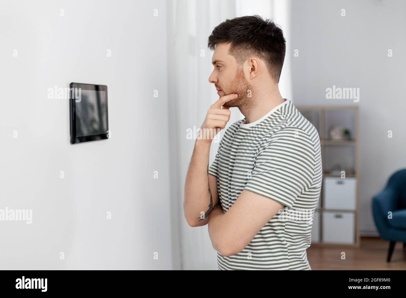 man looking at tablet computer at smart home Stock Photo - Alamy