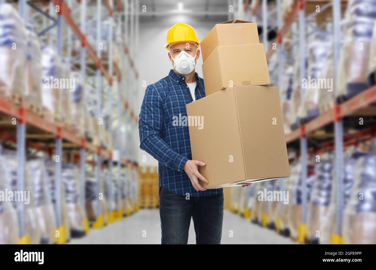 worker in respirator mask with boxes at warehouse Stock Photo - Alamy