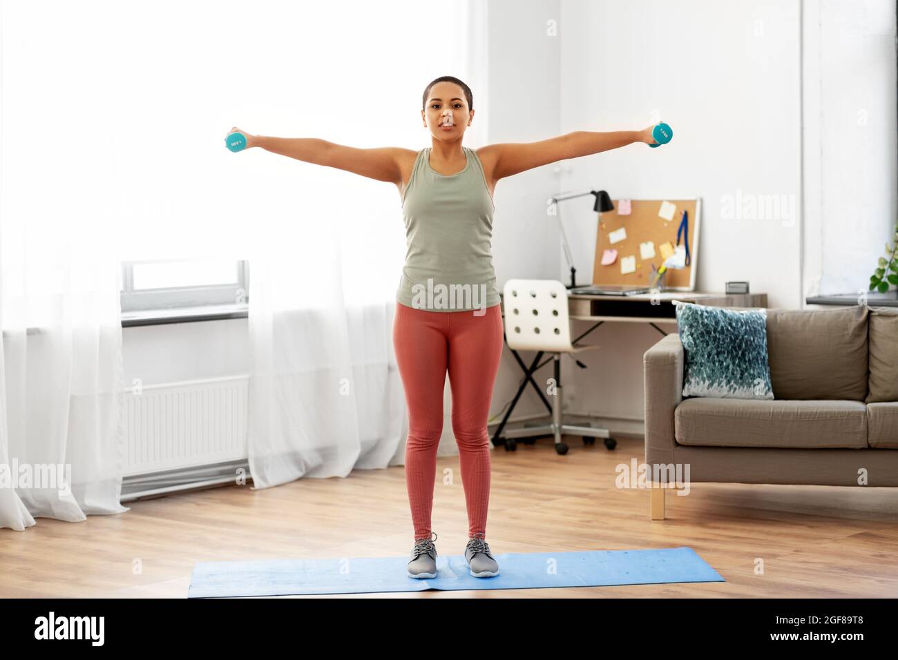 african woman with dumbbells exercising at home Stock Photo - Alamy