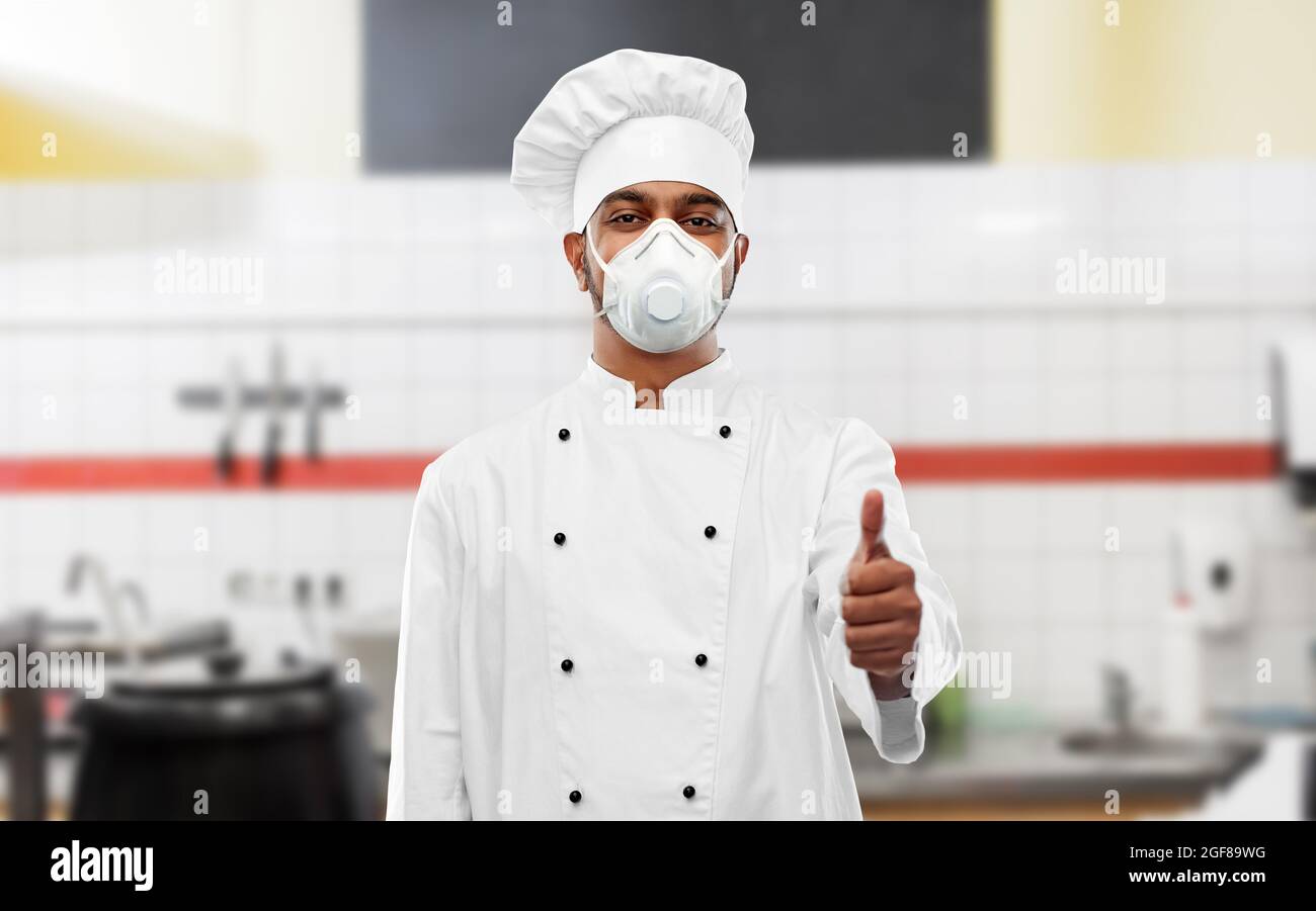 chef in respirator showing thumbs up at kitchen Stock Photo - Alamy