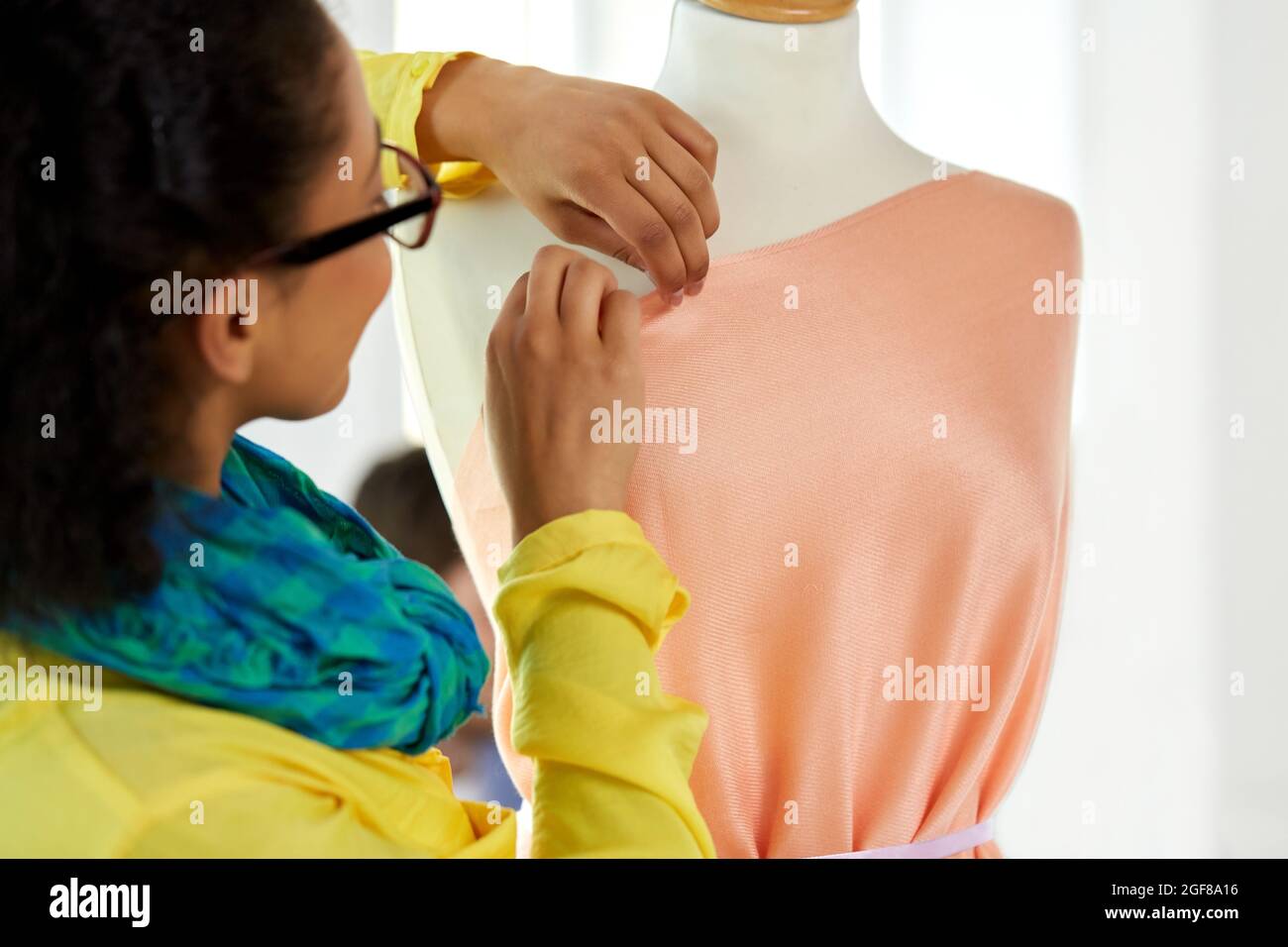 fashion designer with dummy making dress at studio Stock Photo - Alamy