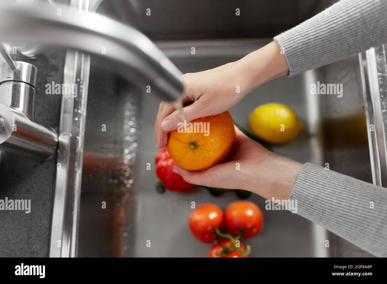 woman washing fruits and vegetables in kitchen Stock Photo - Alamy