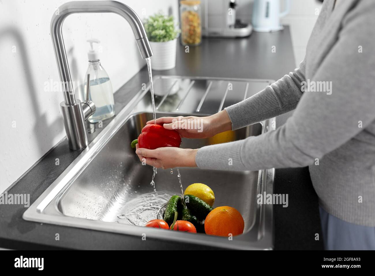 woman washing fruits and vegetables in kitchen Stock Photo - Alamy