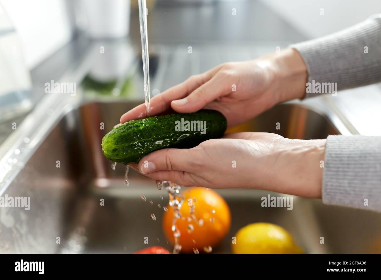 woman washing fruits and vegetables in kitchen Stock Photo - Alamy