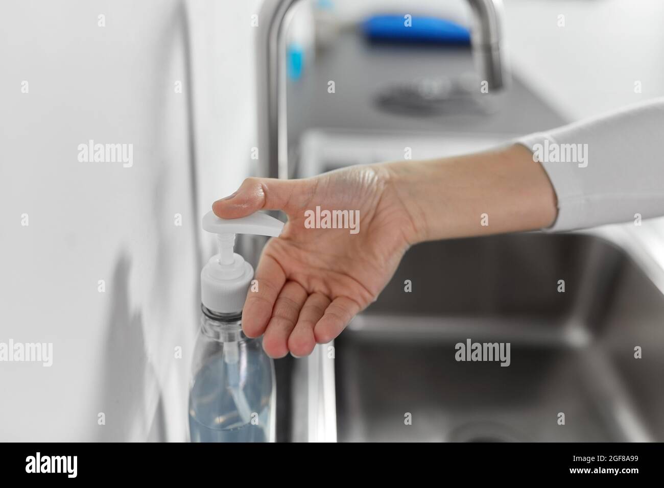 woman washing hands with liquid soap in kitchen Stock Photo - Alamy