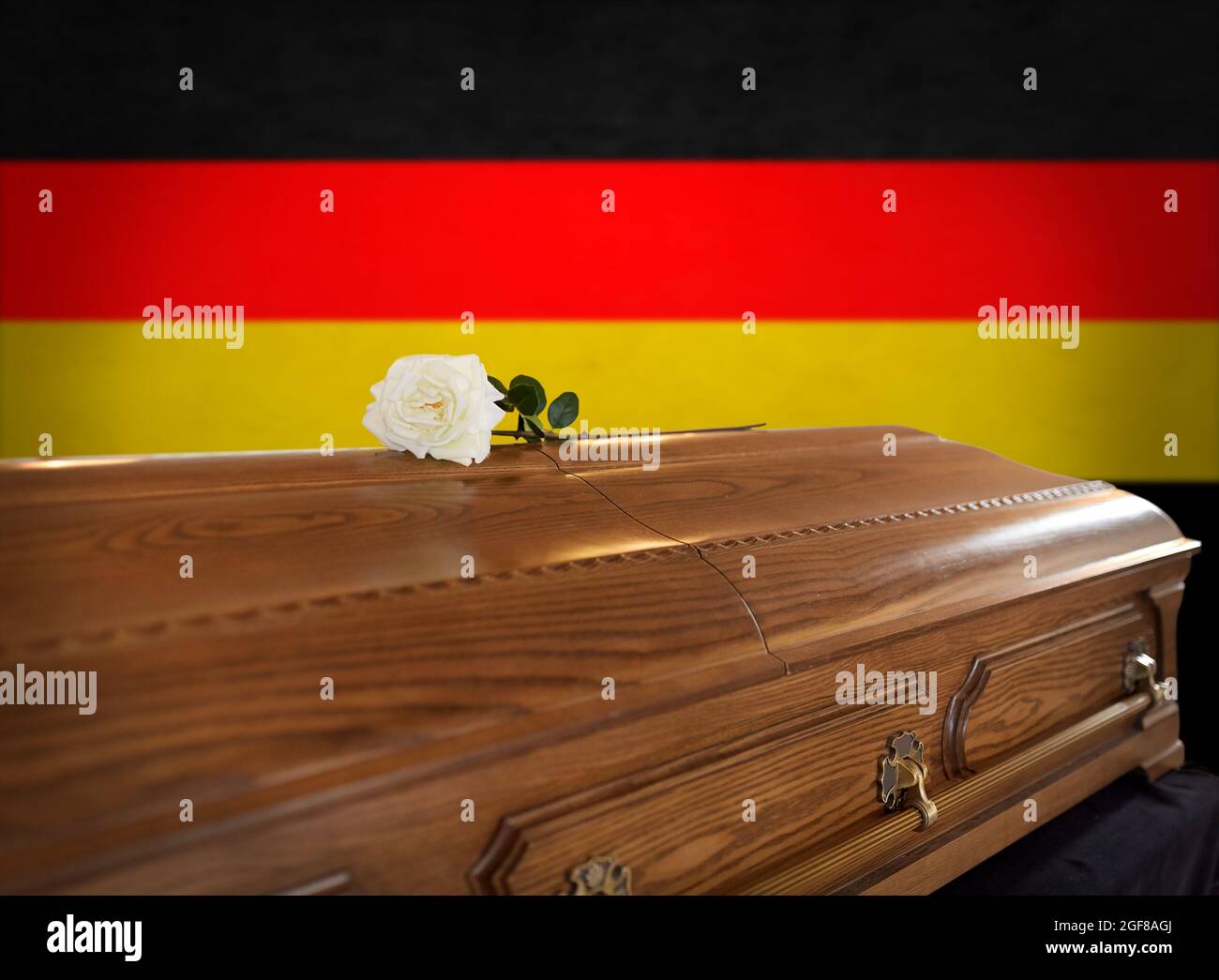 white rose on wooden coffin over flag of germany Stock Photo - Alamy