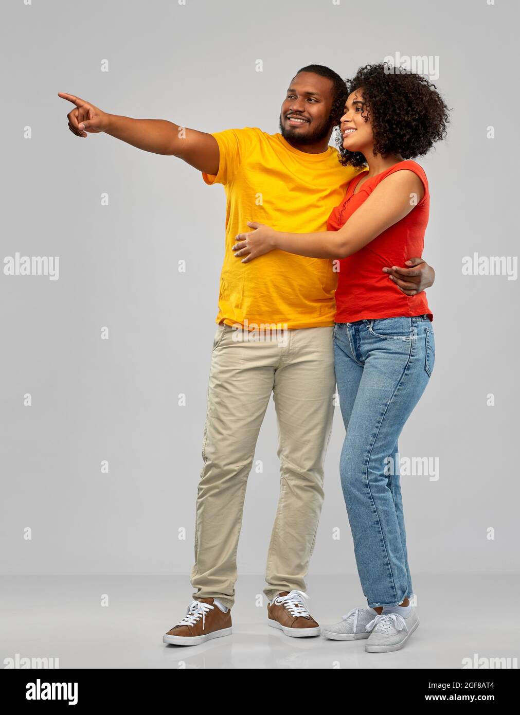 african american couple pointing to something Stock Photo - Alamy
