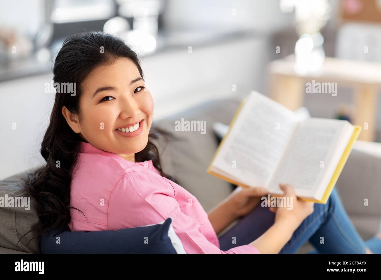 Smiling asian female reading hi-res stock photography and images - Alamy