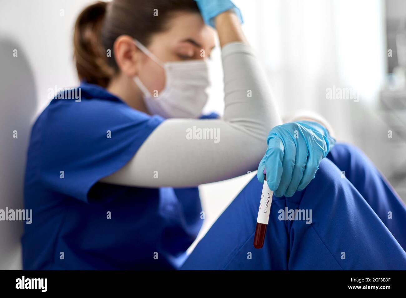 sad doctor or nurse holding beaker with blood test Stock Photo - Alamy