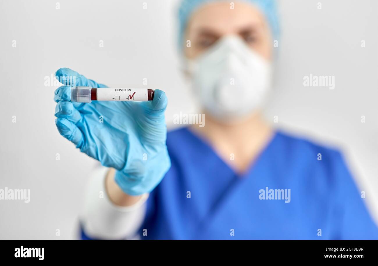 Doctor holding beaker coronavirus blood hi-res stock photography and ...