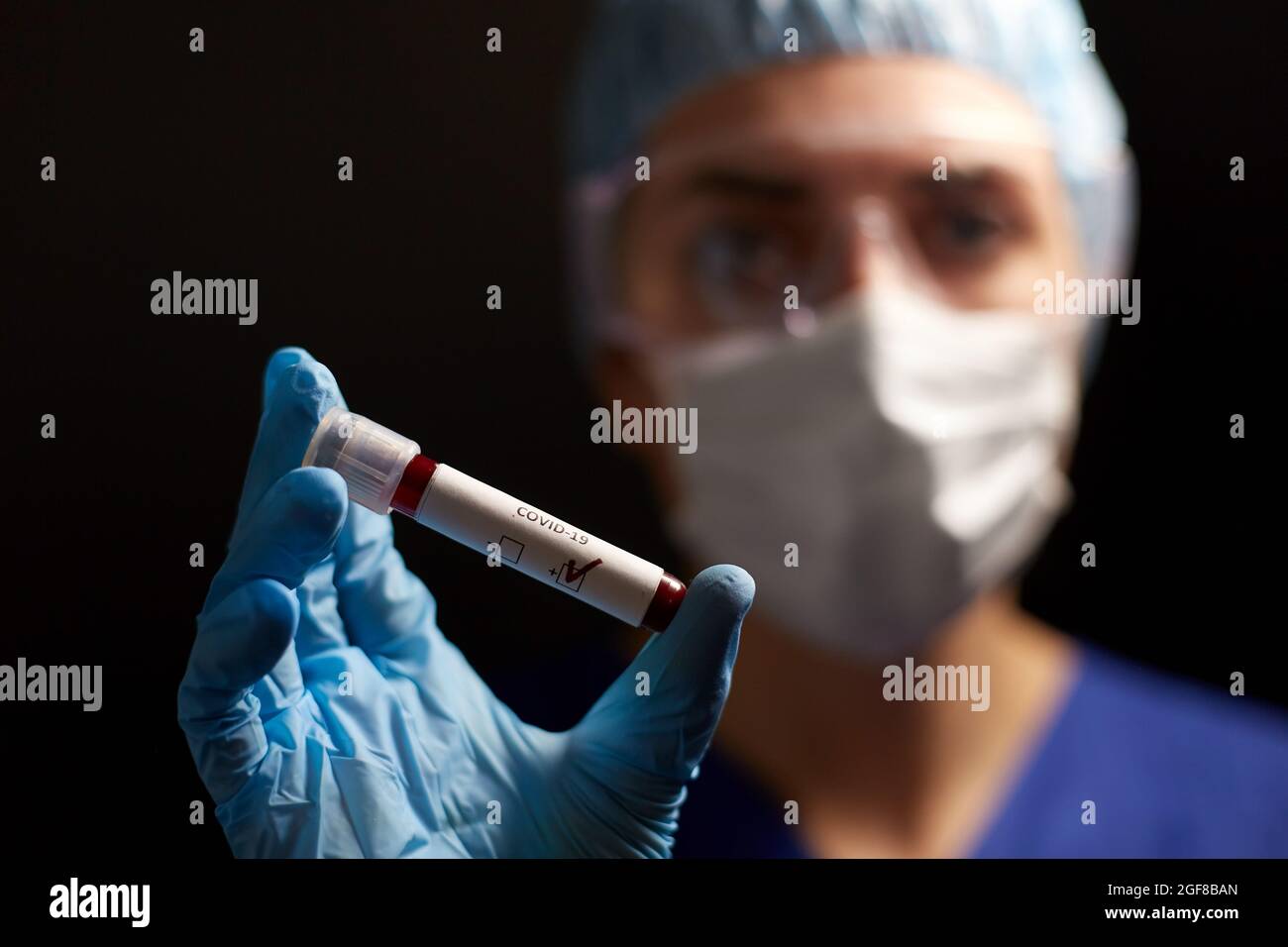 Doctor holding beaker coronavirus blood hi-res stock photography and ...
