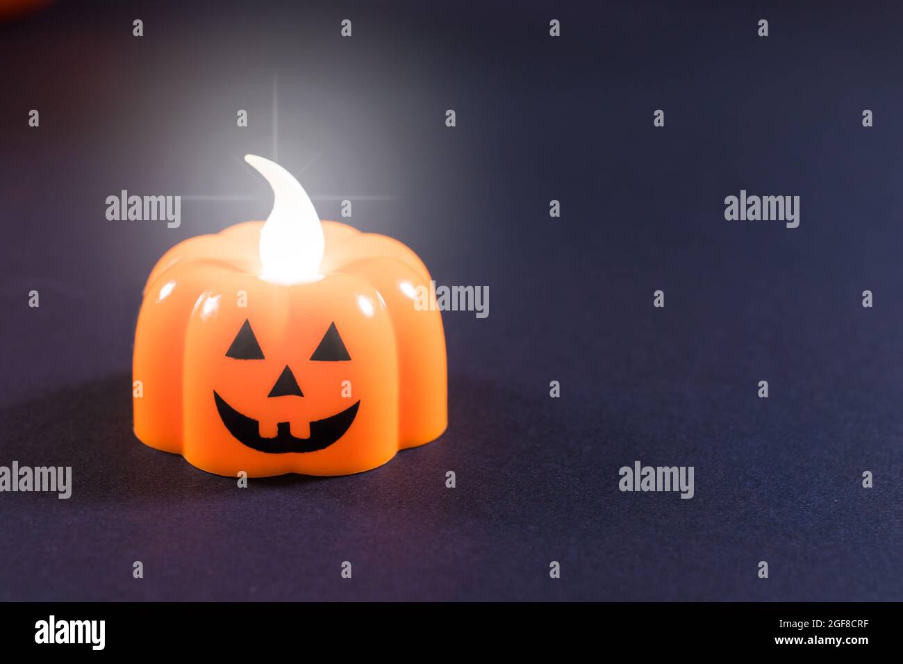 Halloween banner place for text - a candle in the form of a pumpkin ...